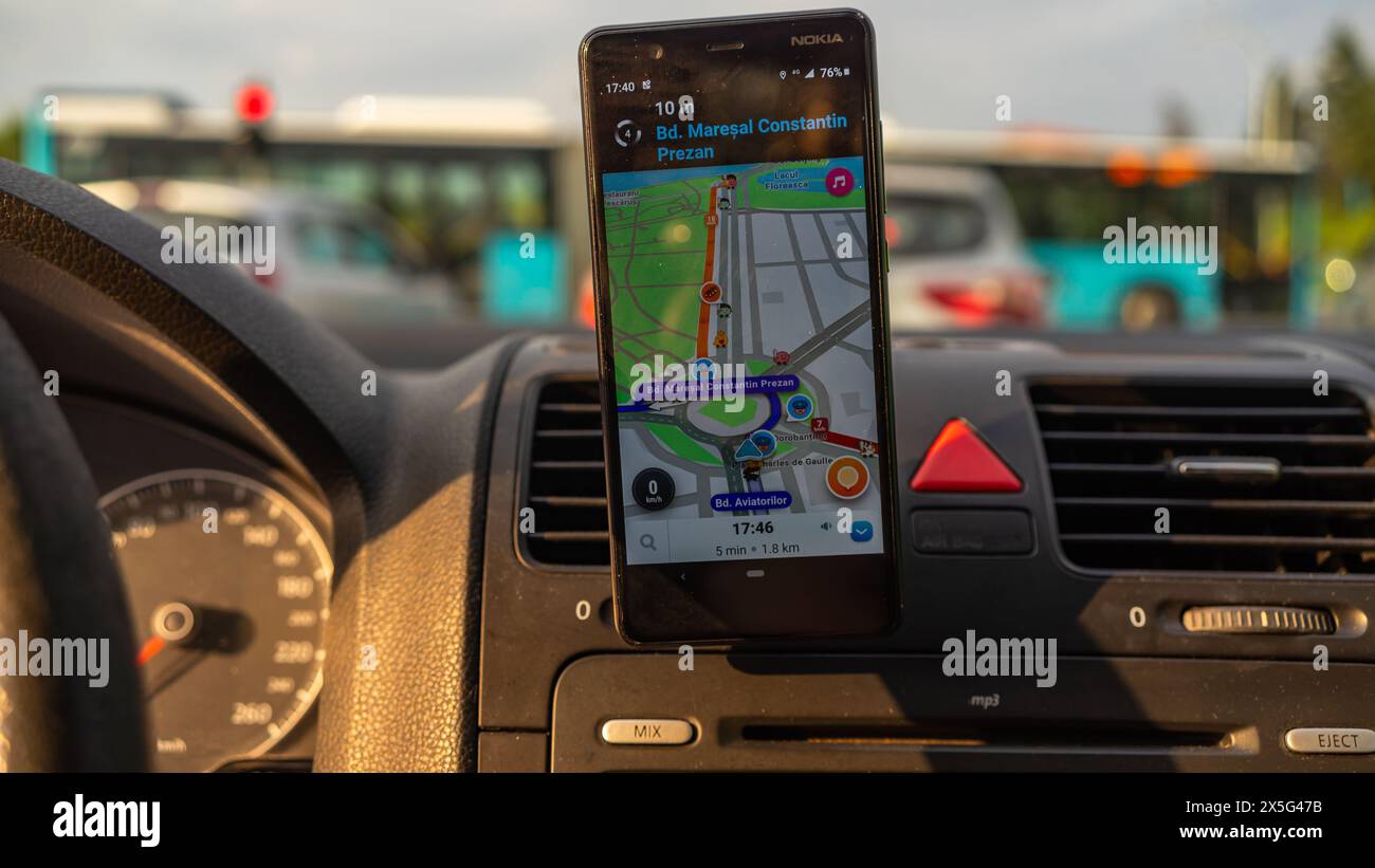 Smartphone showing Waze maps to show the way thru the city. Driver ...