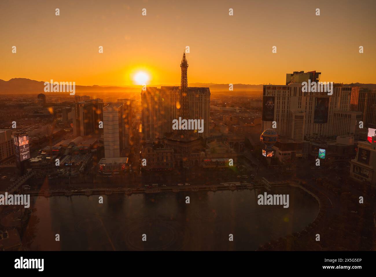 Aerial view of Las Vegas Strip skyline at sunset, dramatic sun flare ...