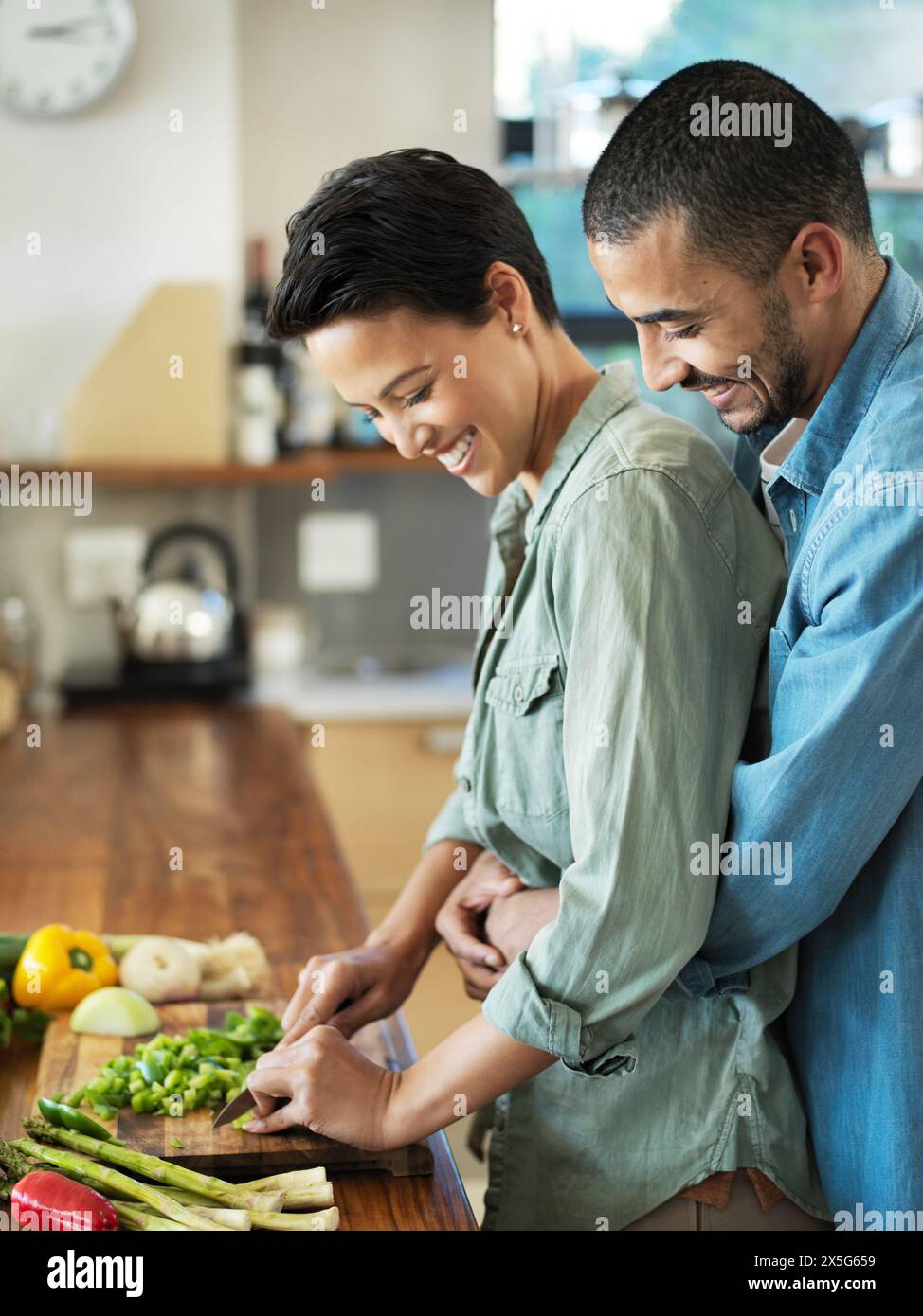 Vegan cooking, hug and couple in kitchen with smile for love, healthy ...