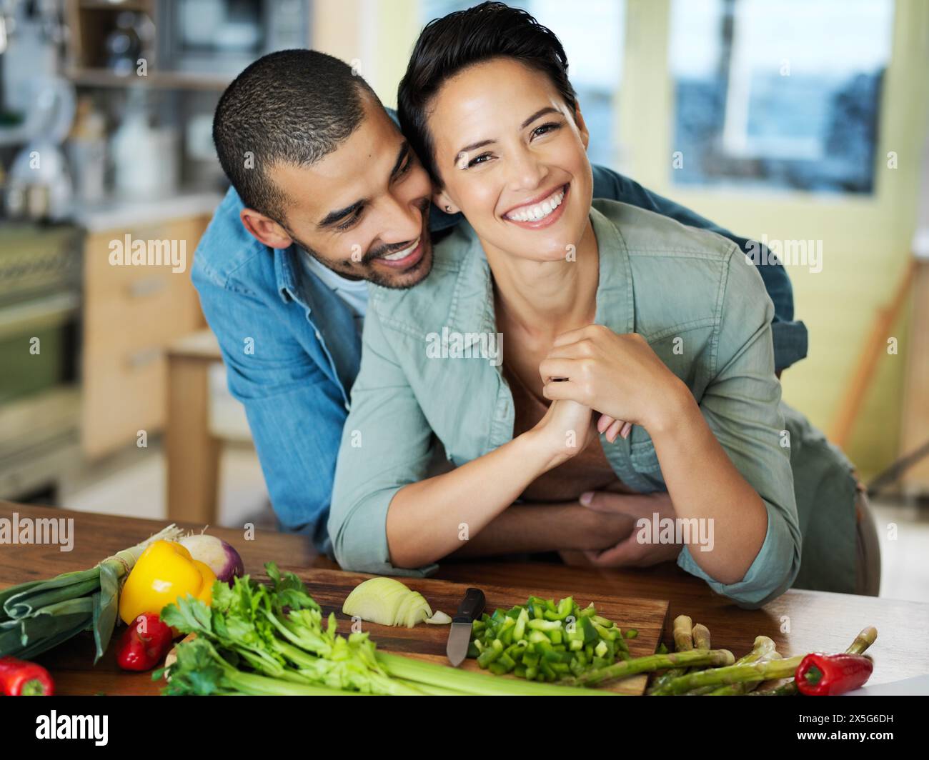 Cooking, vegan and couple hug at kitchen counter for love, healthy food ...