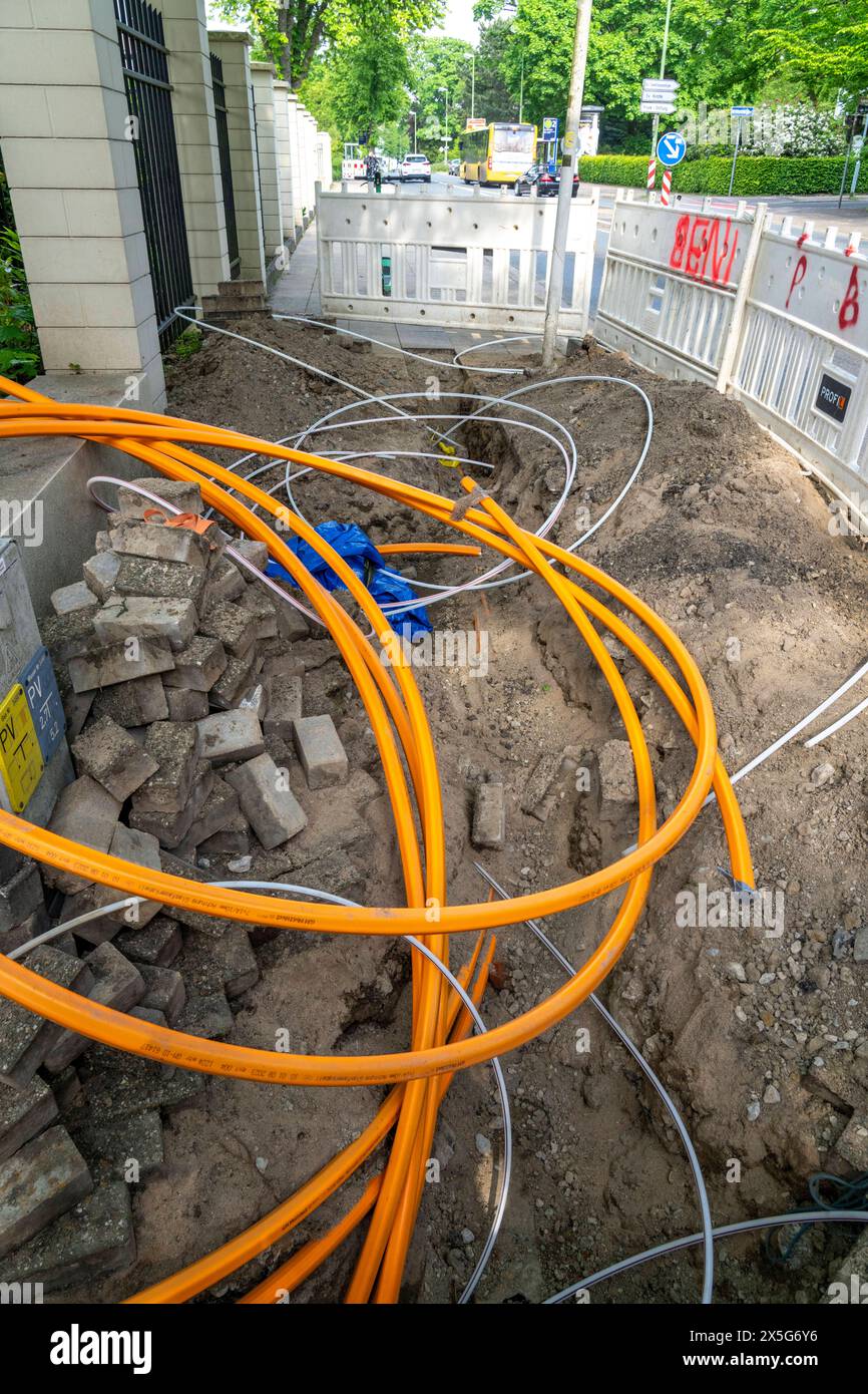 Verlegung von Glasfaserkabeln, Leerrohre werden unter einem Gehweg ...