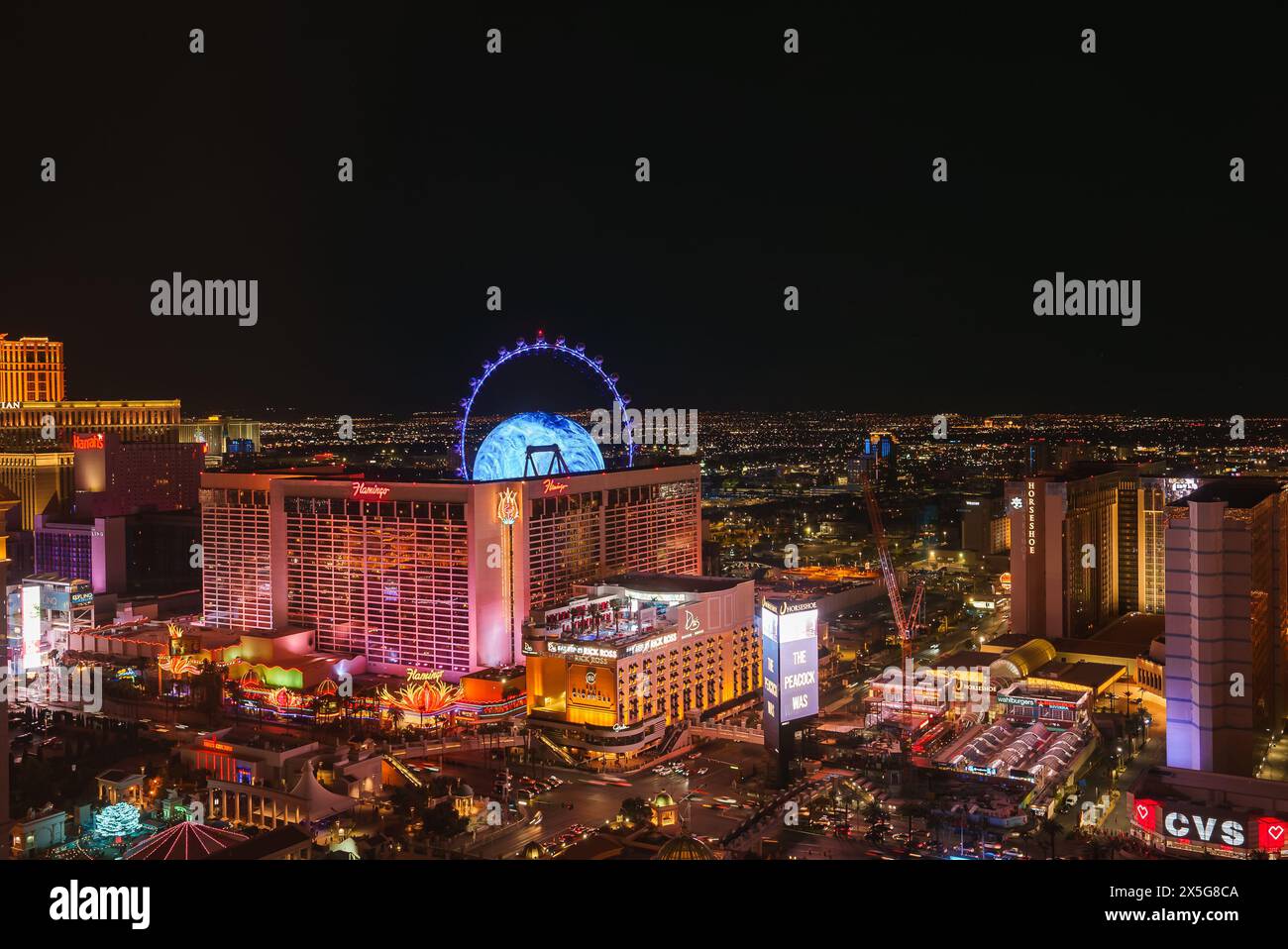 Vibrant Aerial Night View of Las Vegas Strip, Observation Wheel and Neon Lights at City Center ...