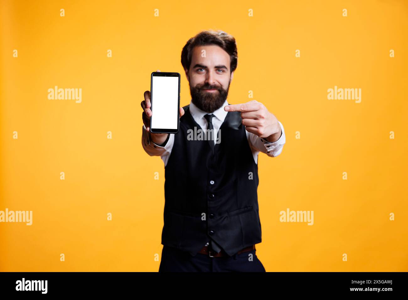 Confident waiter points to white screen on camera, presenting isolated ...