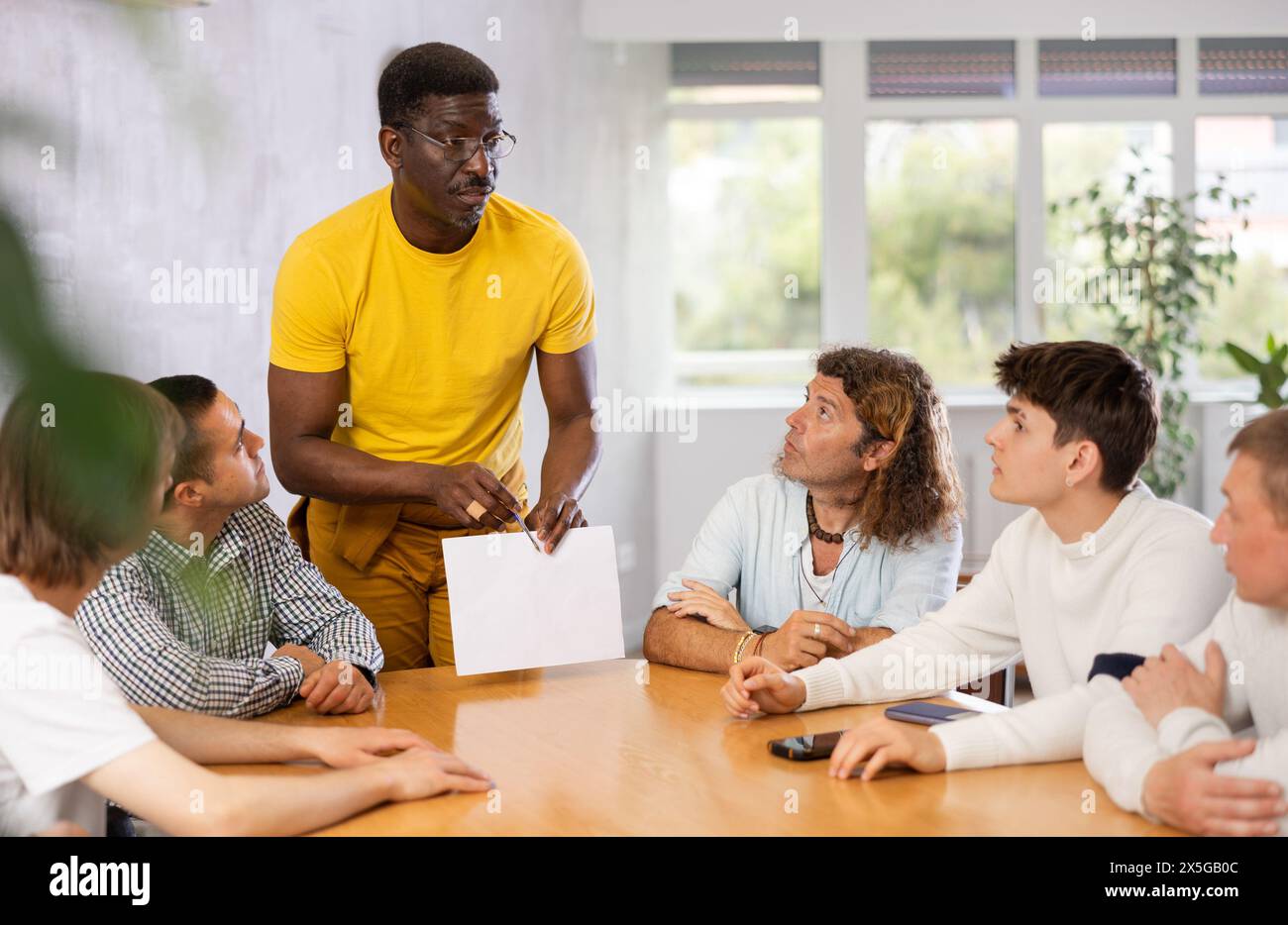 African american showing papers during meeting with male colleagues ...