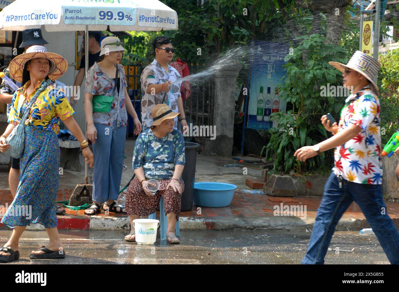 People using hoses and buckets as part of the Pi Mai Parade, Lao New ...