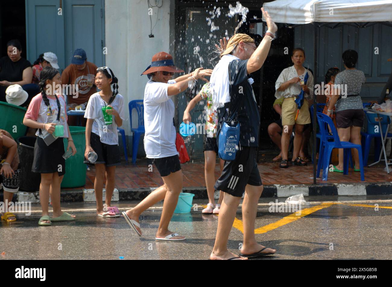 People using hoses and buckets as part of the Pi Mai Parade, Lao New ...