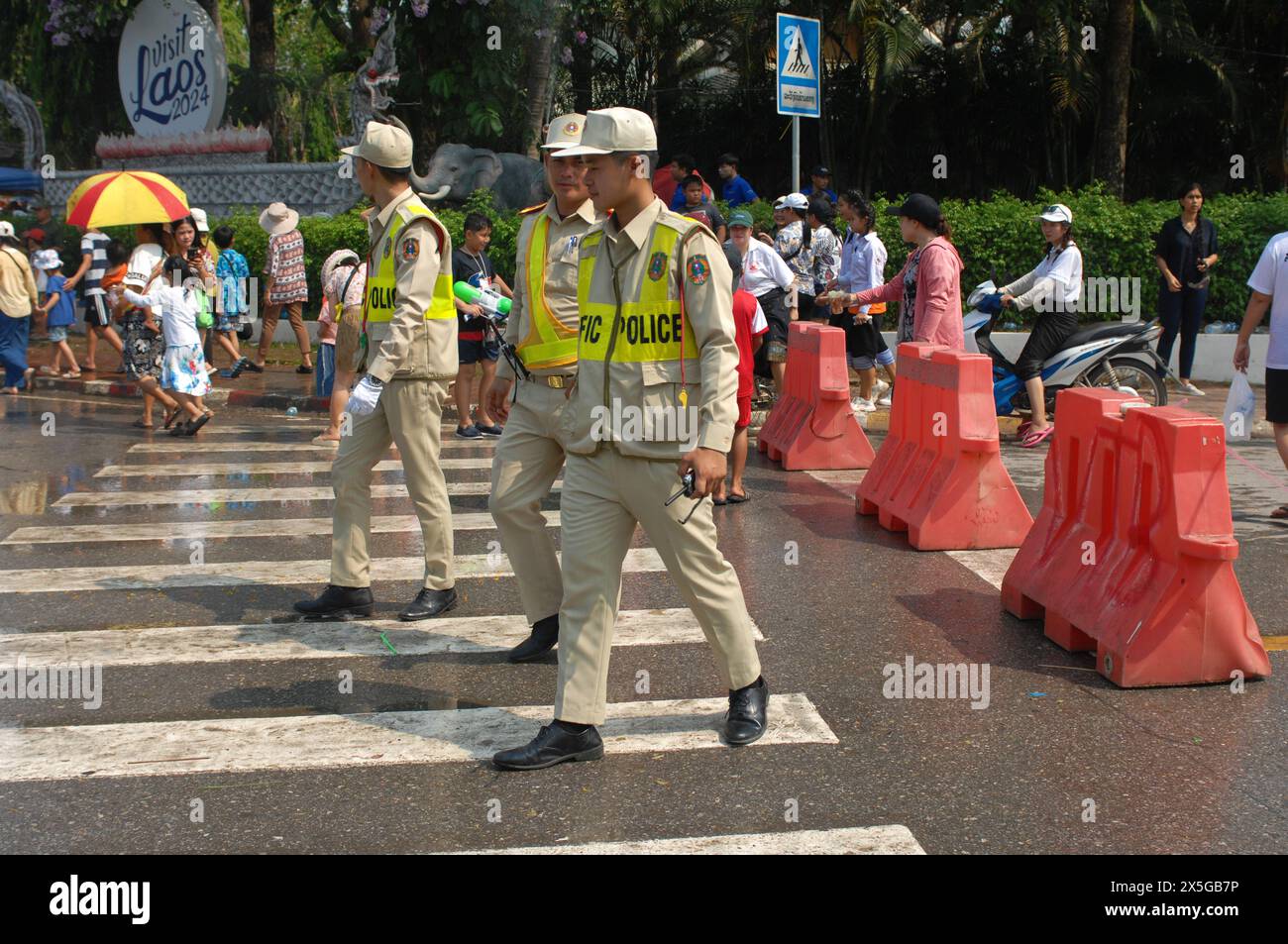 Traffic Police move barriers as part of the Pi Mai Parade, Lao New Year ...