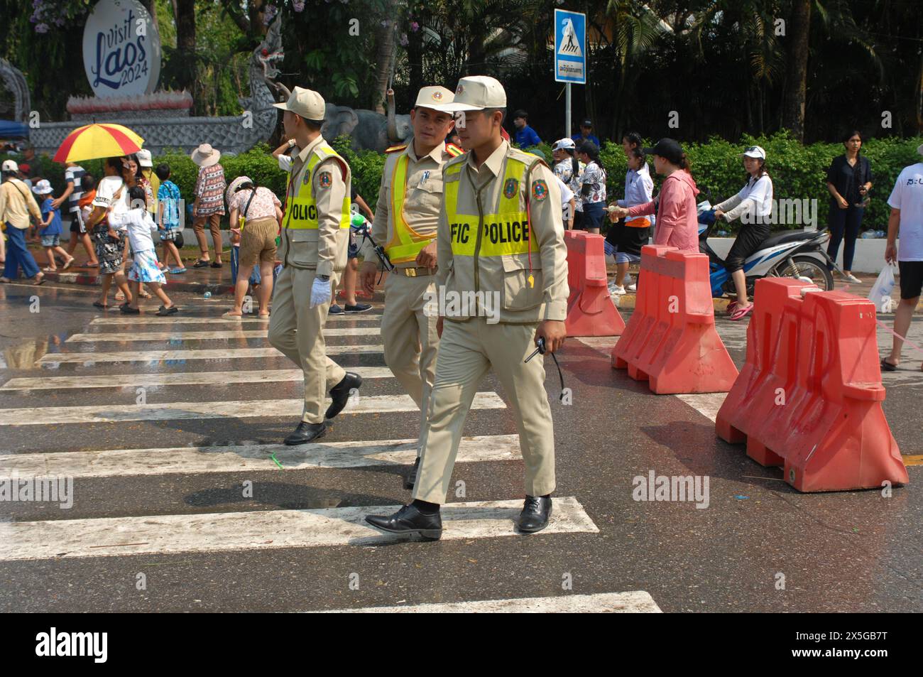 Traffic Police move barriers as part of the Pi Mai Parade, Lao New Year ...