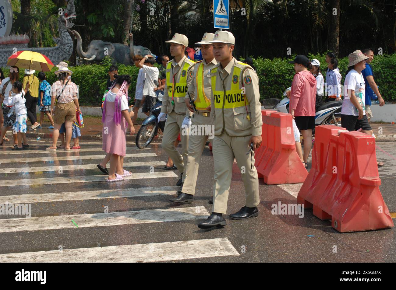 Traffic Police move barriers as part of the Pi Mai Parade, Lao New Year ...
