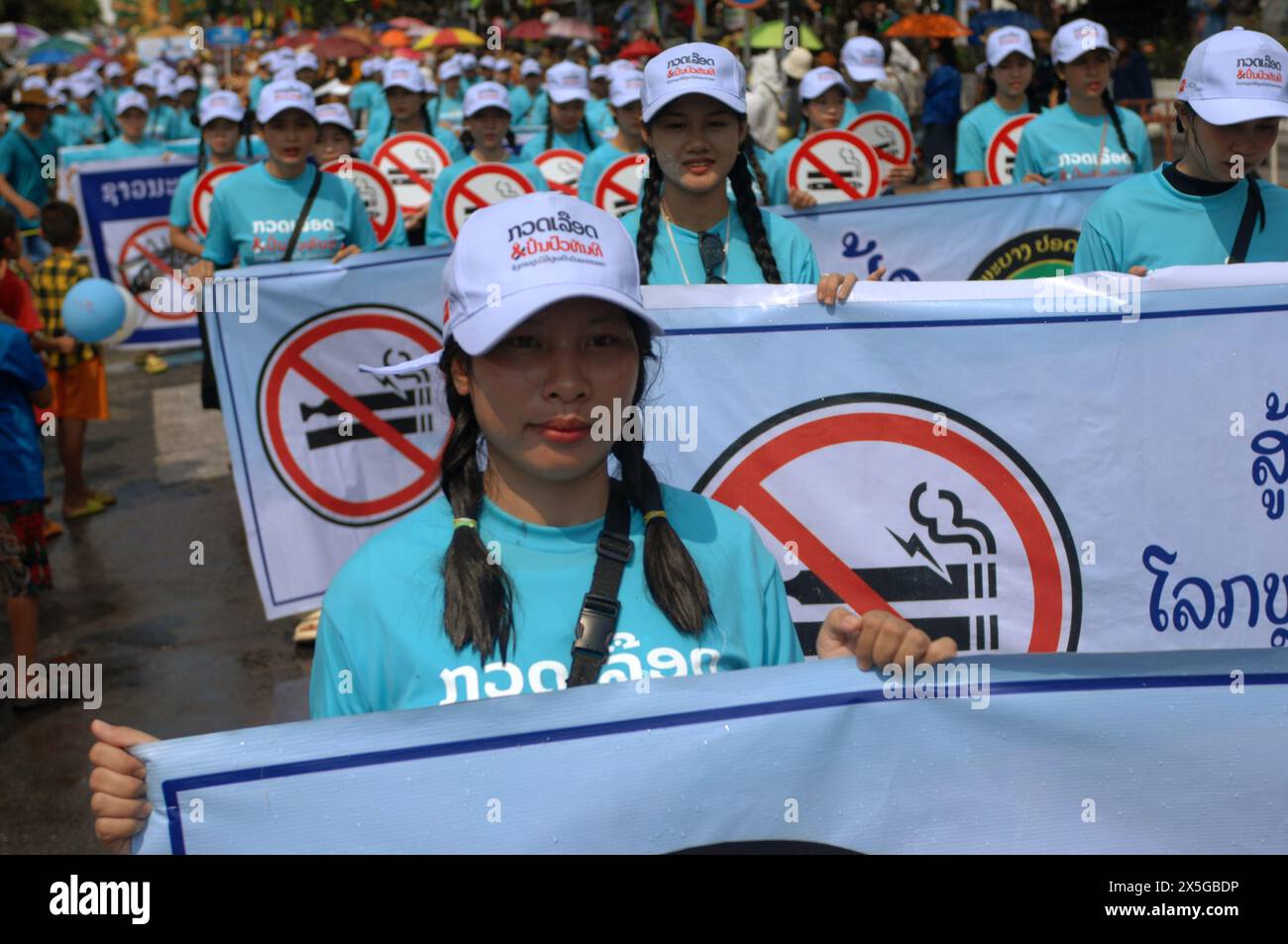 Young people parade as part of the Pi Mai Parade, No Smoking Banner ...