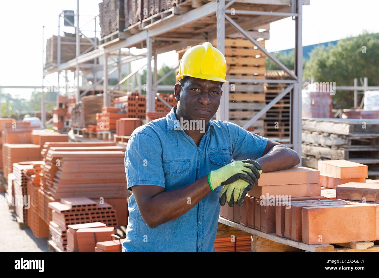 Worker stacking bricks in warehouse of building materials clpseup Stock ...