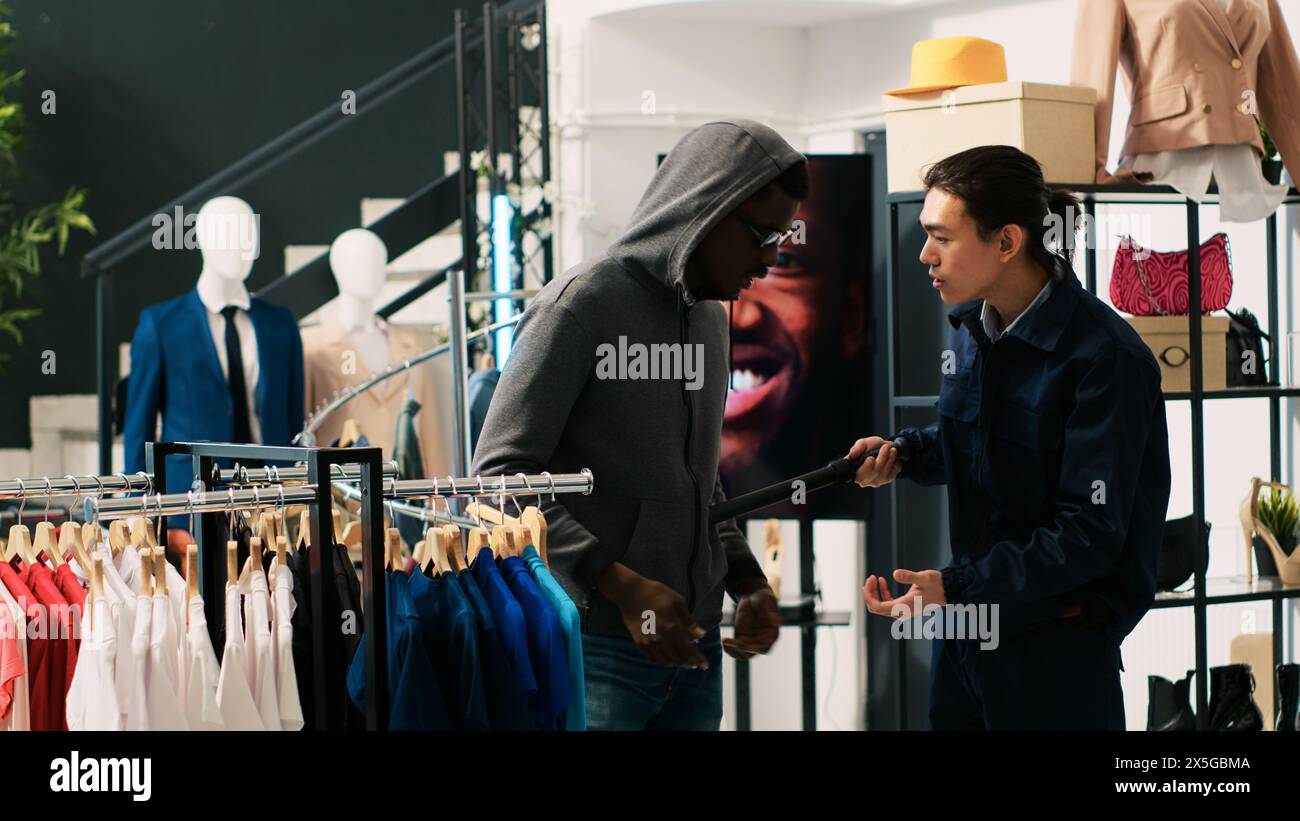 Robber wearing hood and sunglasses while trying to stole fashionable ...