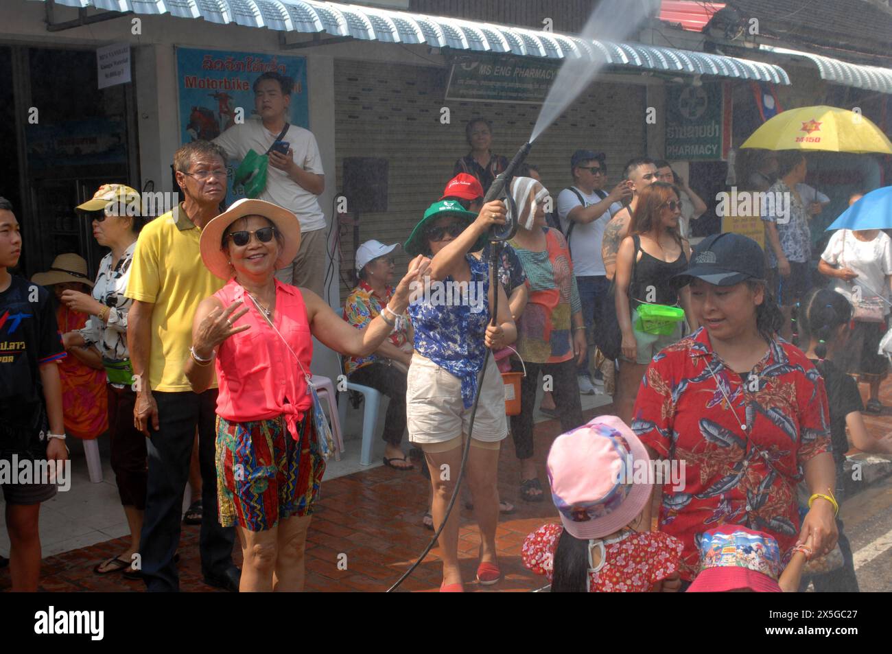 People using hoses and buckets as part of the Pi Mai Parade, Lao New ...