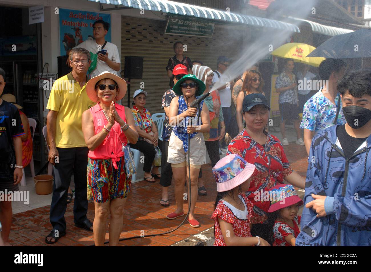 People using hoses and buckets as part of the Pi Mai Parade, Lao New ...