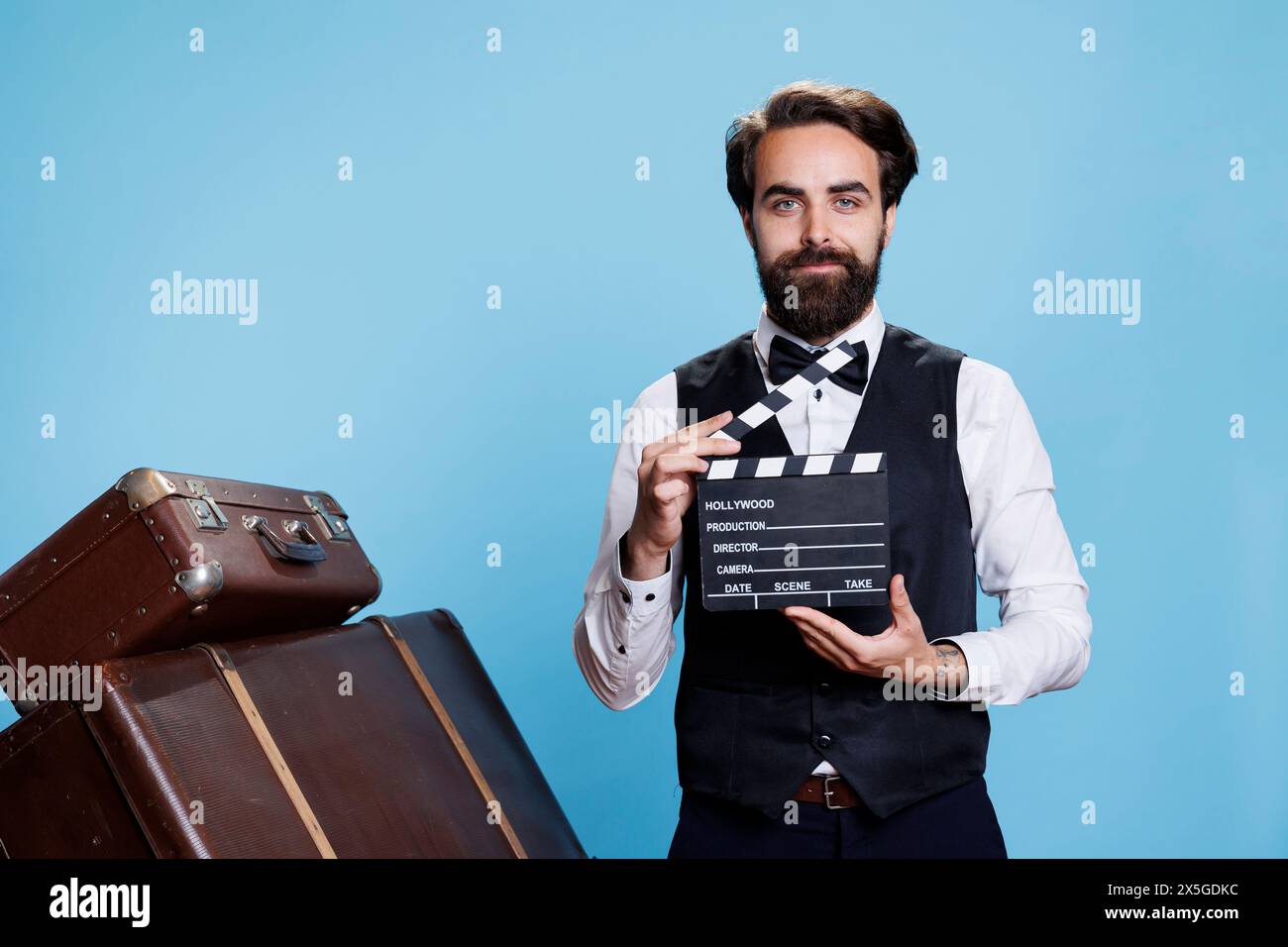 Doorkeeper clapping filmslate on camera, saying action to cut scene for ...