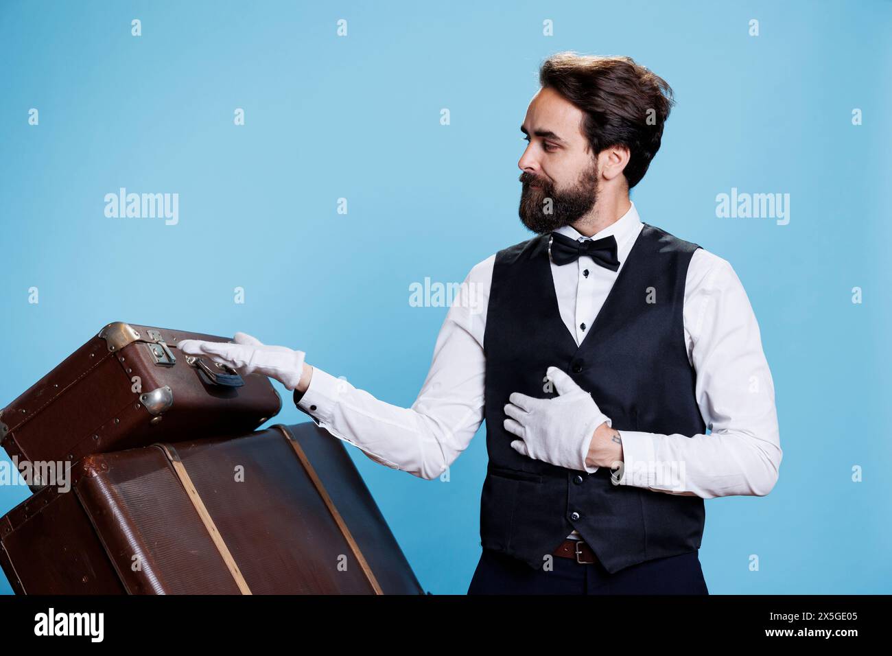 Male bellhop points left and right to create new advertisement ...