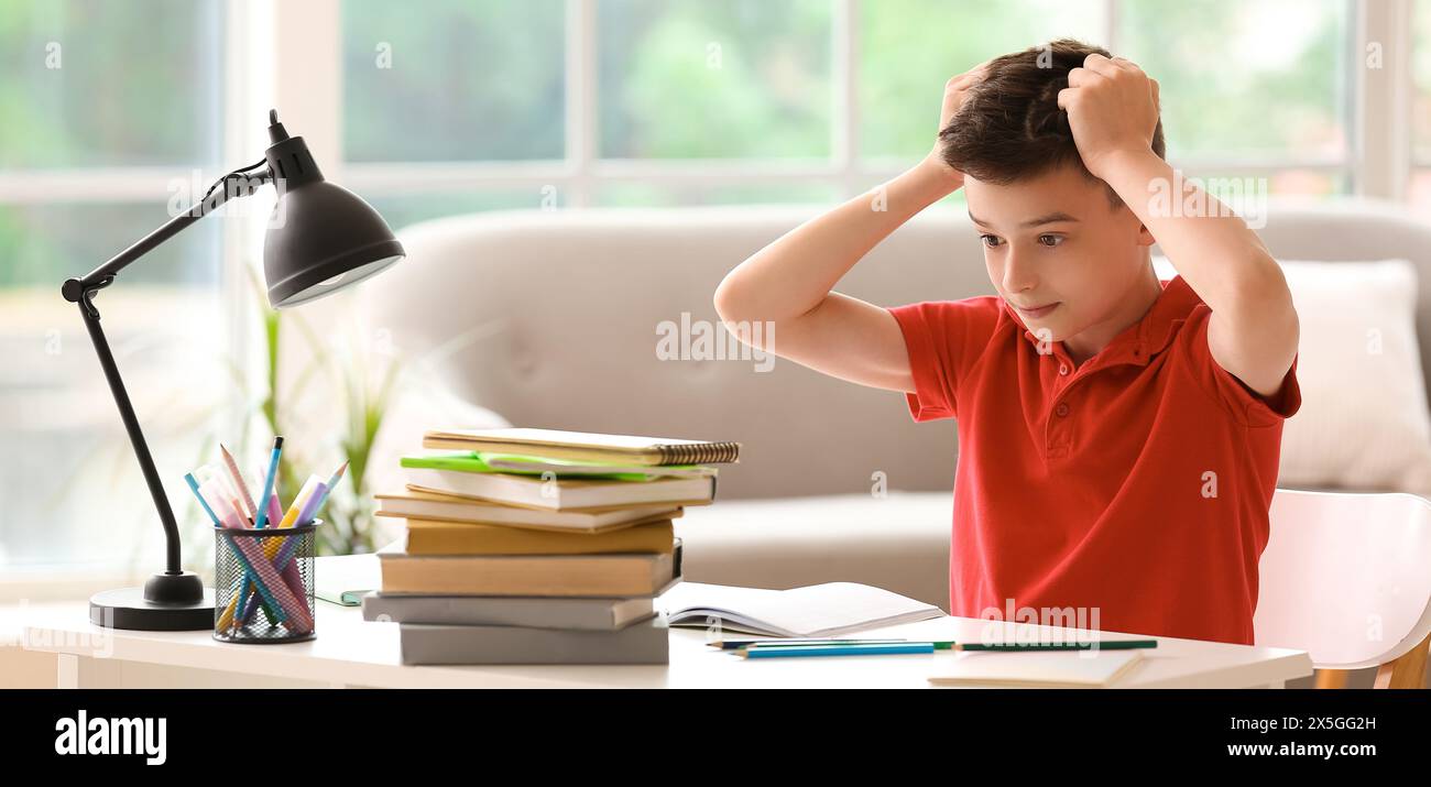 Stressed little boy doing homework at home Stock Photo - Alamy