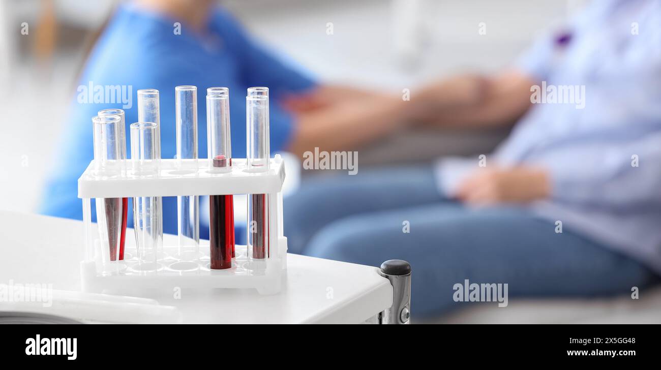Test tubes with blood on table in clinic Stock Photo - Alamy