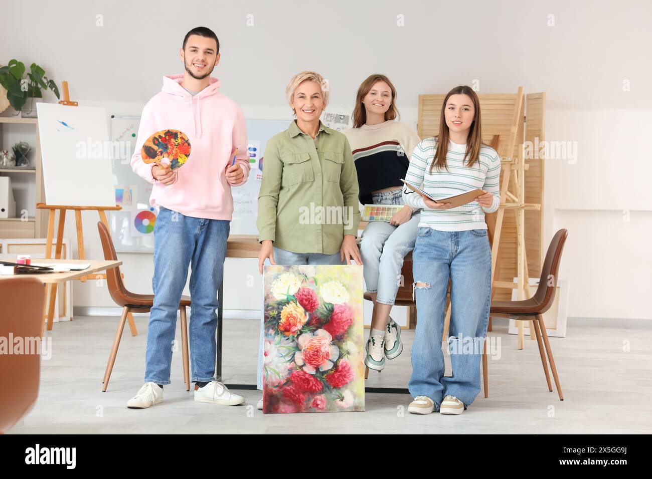 Female art teacher with students at school Stock Photo - Alamy