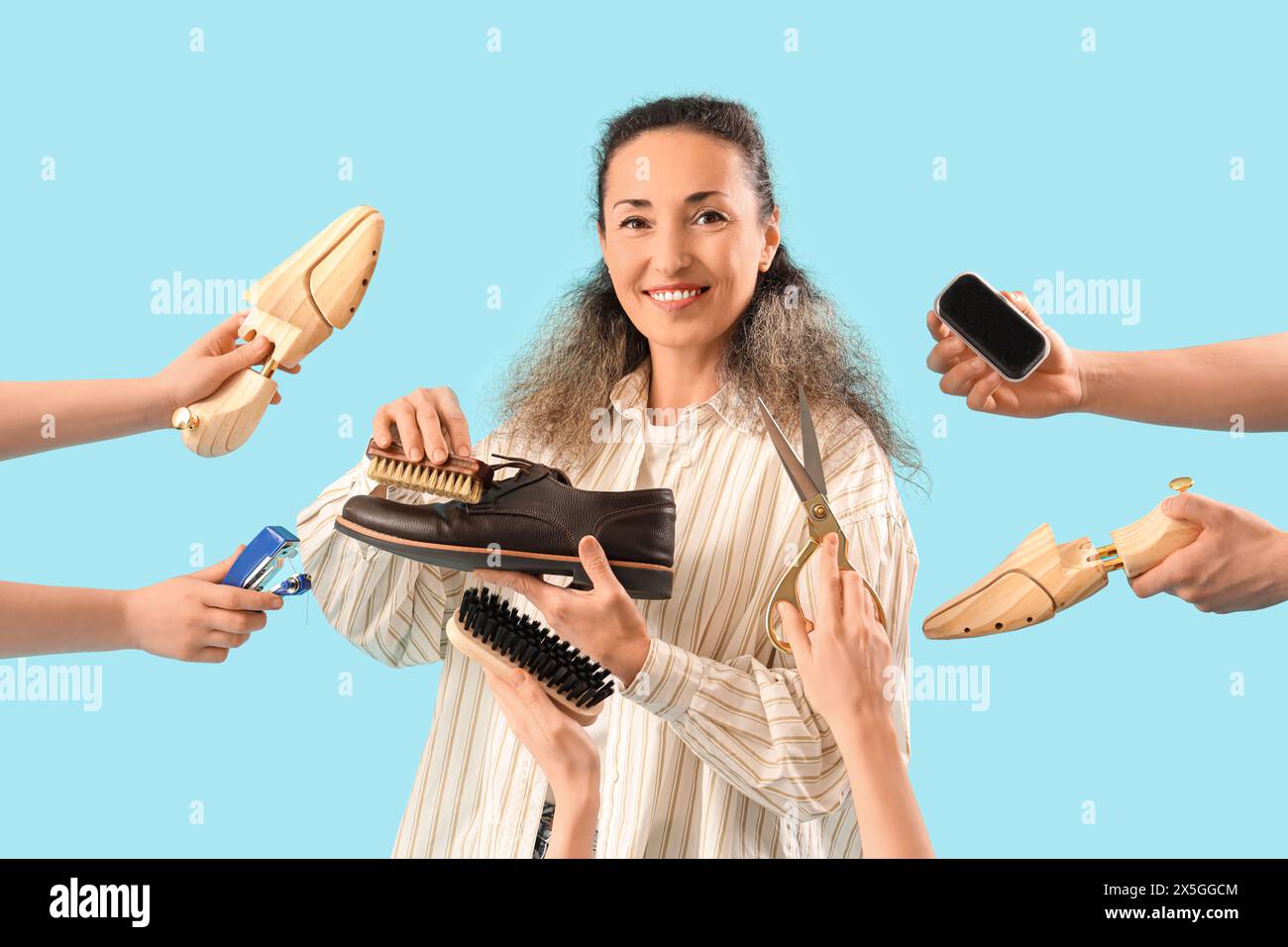 Female shoemaker and hands with tools on blue background Stock Photo ...