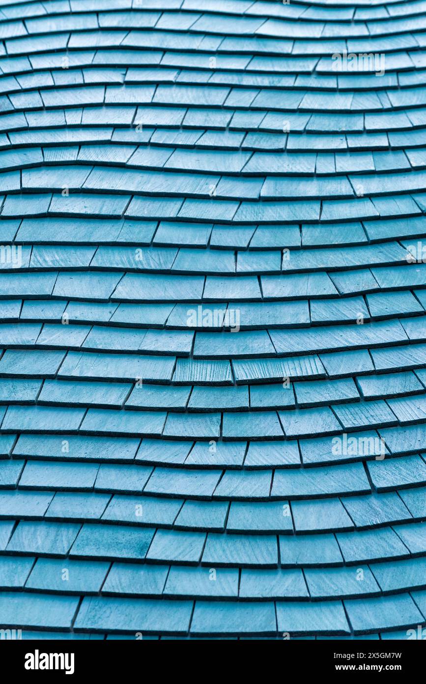 The blue shingles on the roof are weathered and worn. The roof is made ...