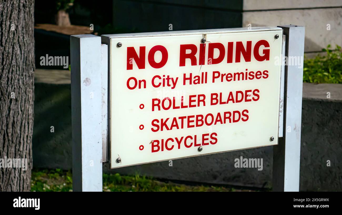 A sign reading "NO RIDING On City Hall Premises - roller blades ...