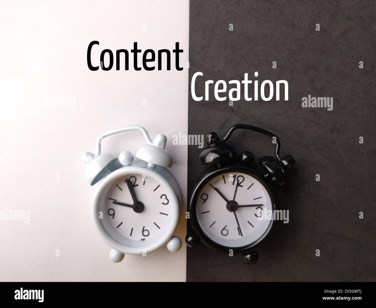 Top view alarm clock with text Content Creation on white and black ...