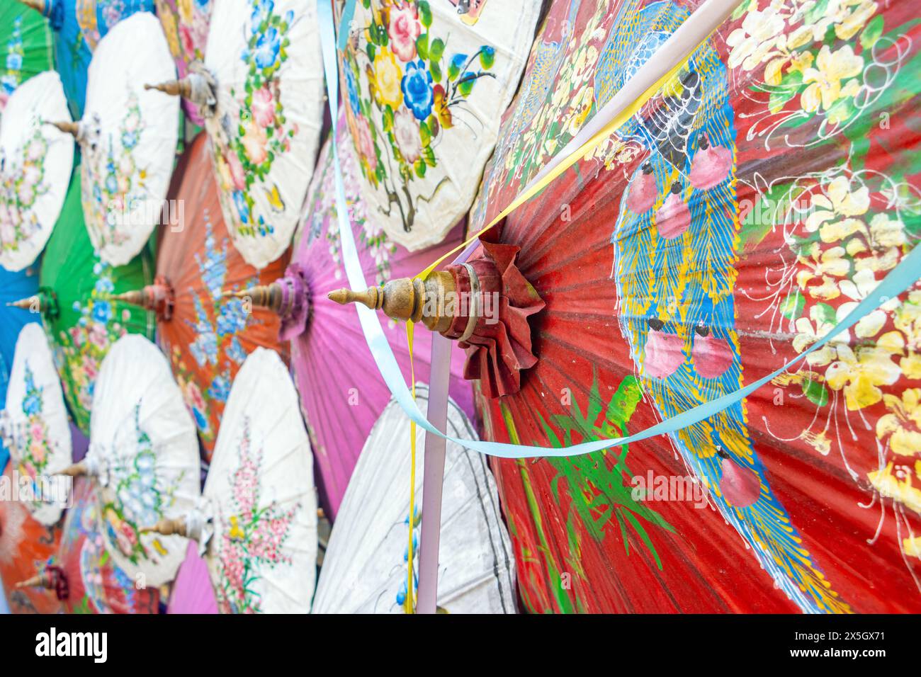 A wall of traditional umbrellas decorated with a painting Stock Photo ...