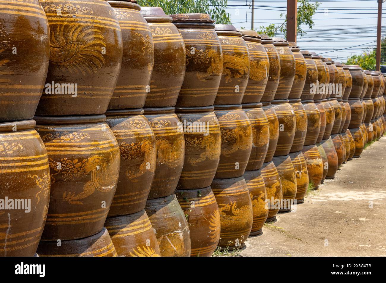 Rows of glazed water containers with a dragon pattern Stock Photo - Alamy