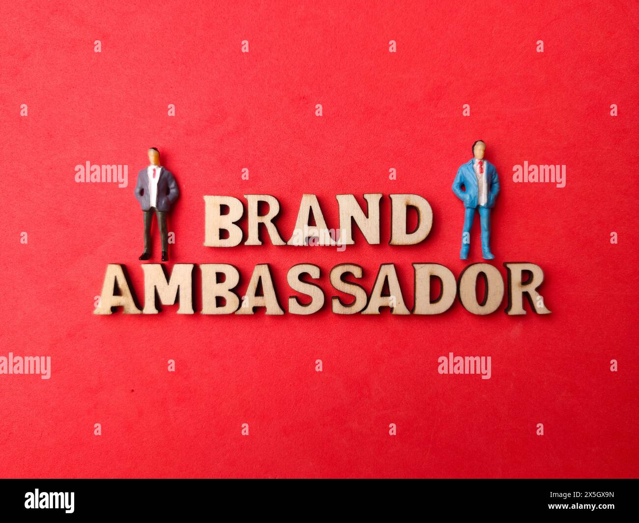 Top view miniature people and wooden word with text BRAND AMBASSADOR on ...