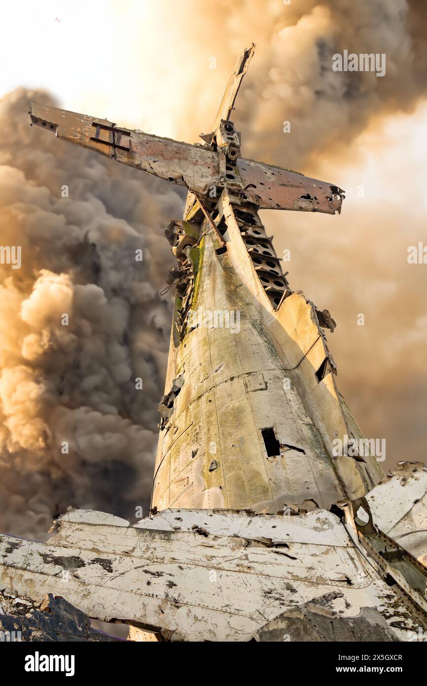 Wreckage of a crashed plane with smoke in the sky Stock Photo - Alamy