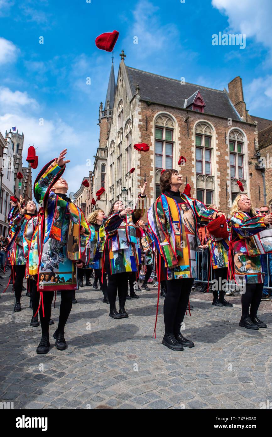 Women sing and throw their hats in the air during the Catholic festival ...