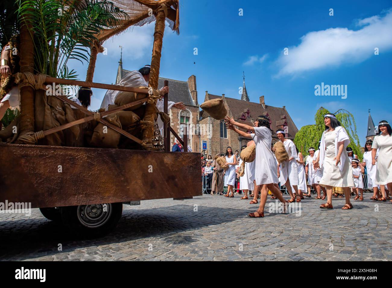 A man dressed as Mosses from the Bible throws sacks of food to ...