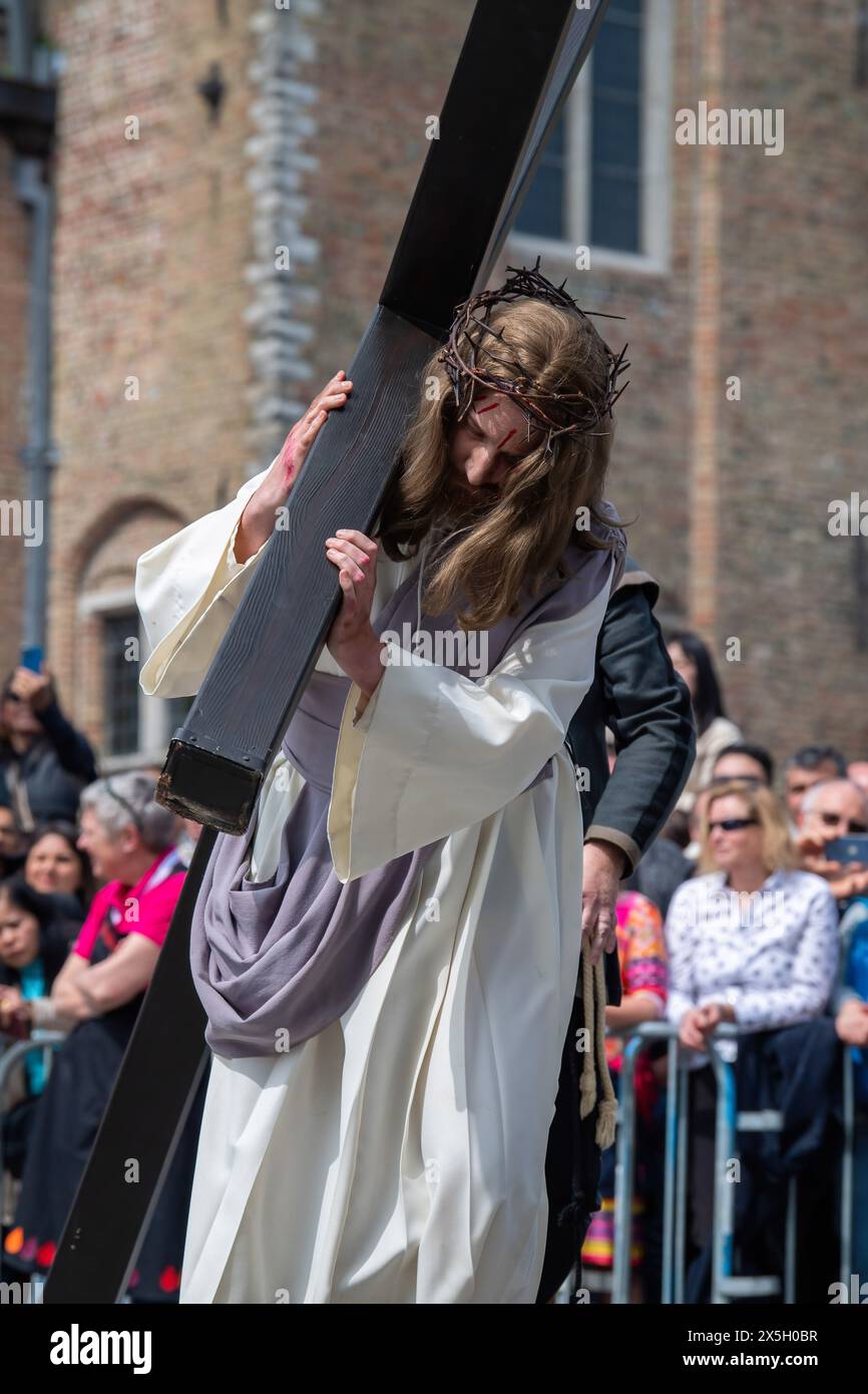 A man dressed as Jesus Christ carries a cross during the Catholic ...