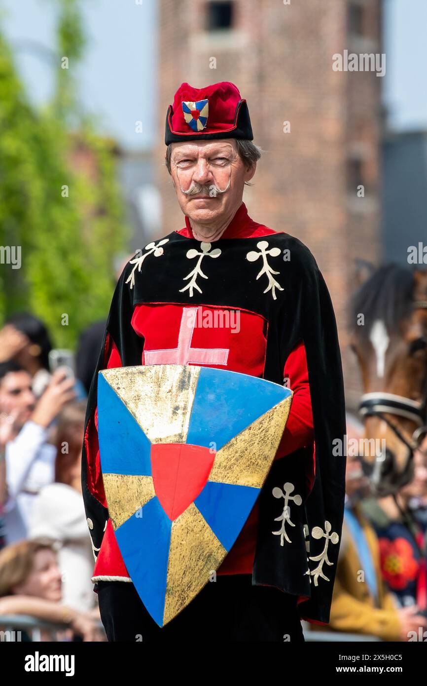A man with a prominent mustache carries a shield during the Catholic ...