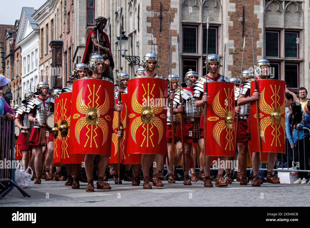 Men dressed as Roman legionnaires lead a statue of the suffering Christ ...