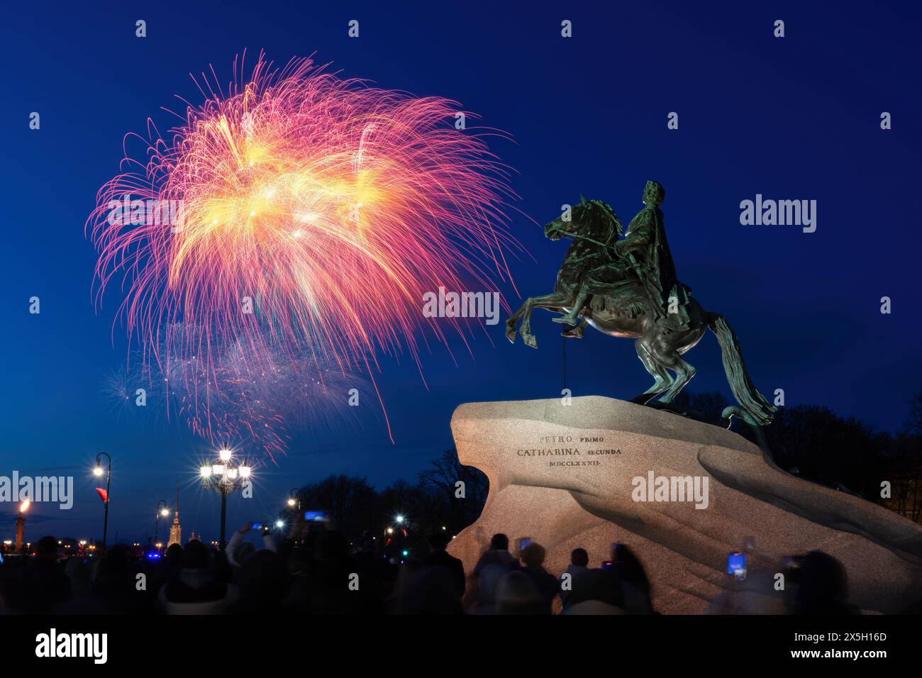 People watch the fireworks against the backdrop of the "Bronze Horseman ...