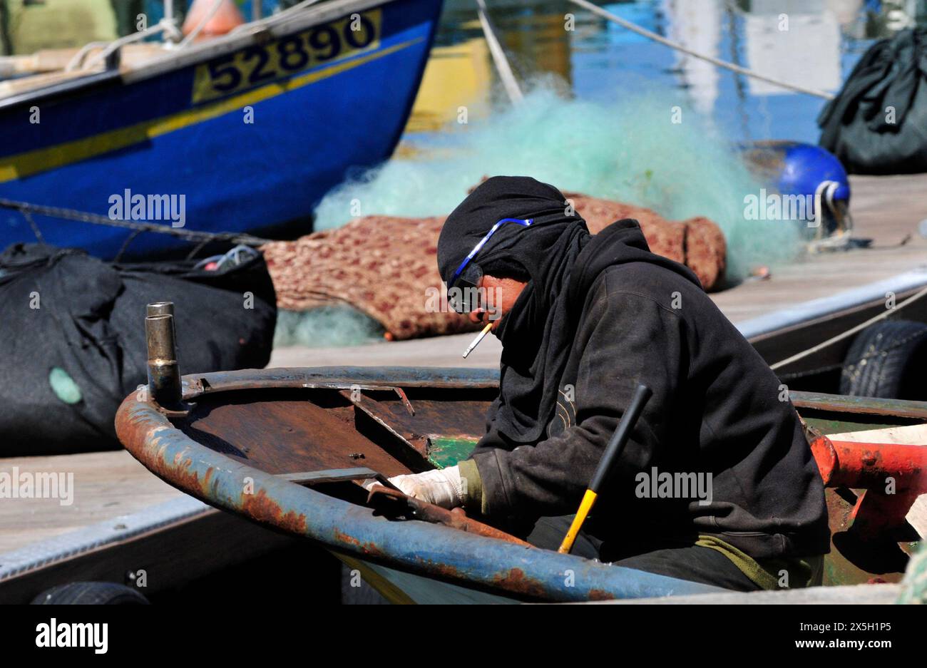 A man fixing a boat at the old port of Jaffa, Israel Stock Photo - Alamy