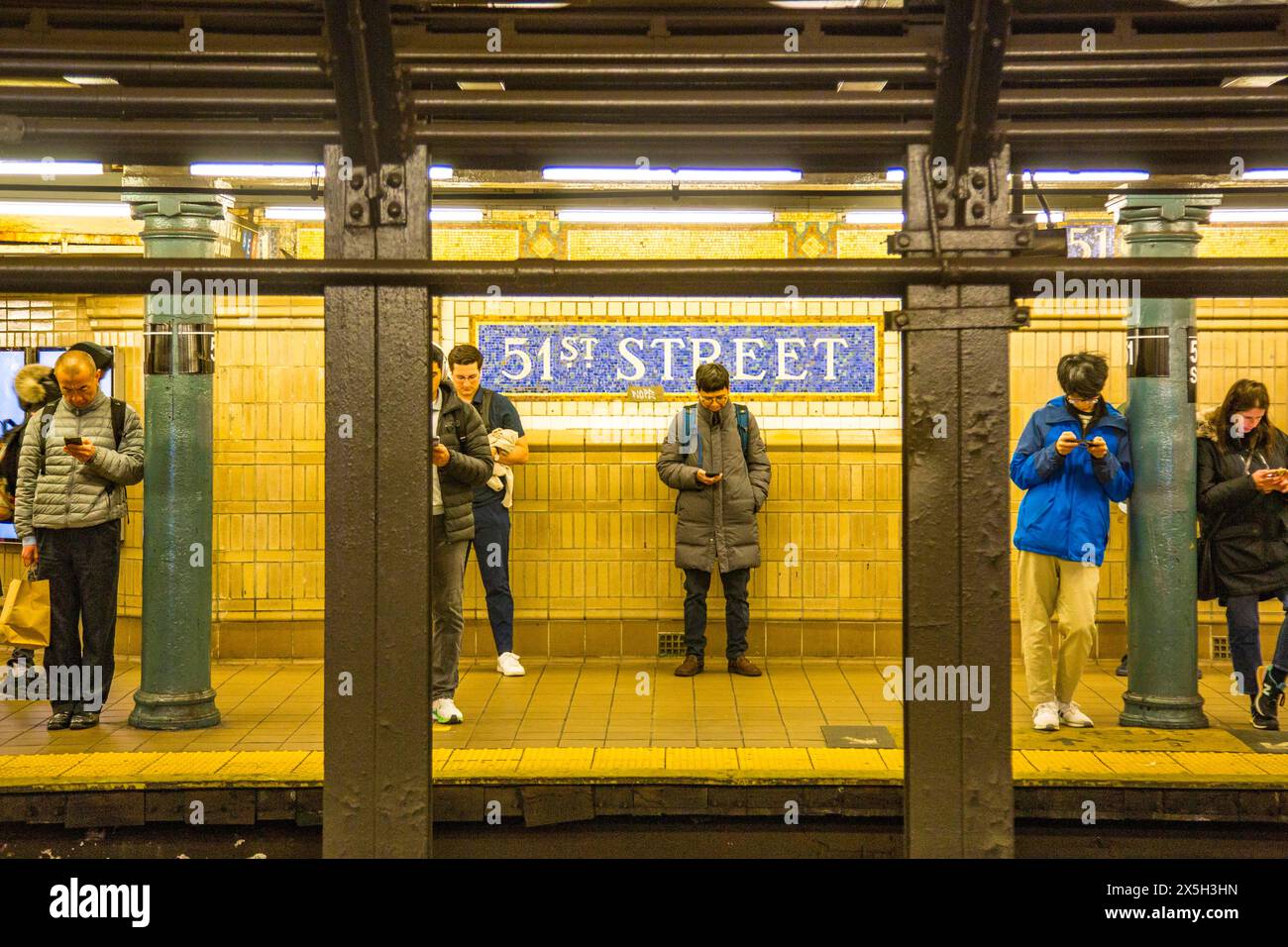 Waiting underground passengers at 51st St subway station, New York City ...