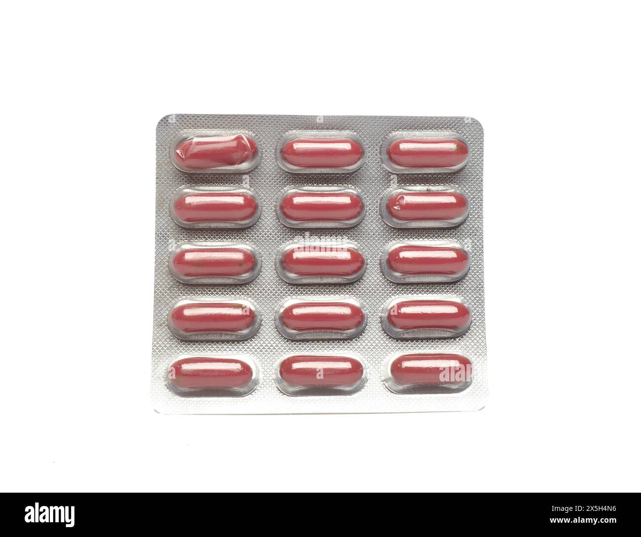red capsule in wrapper isolated Stock Photo - Alamy
