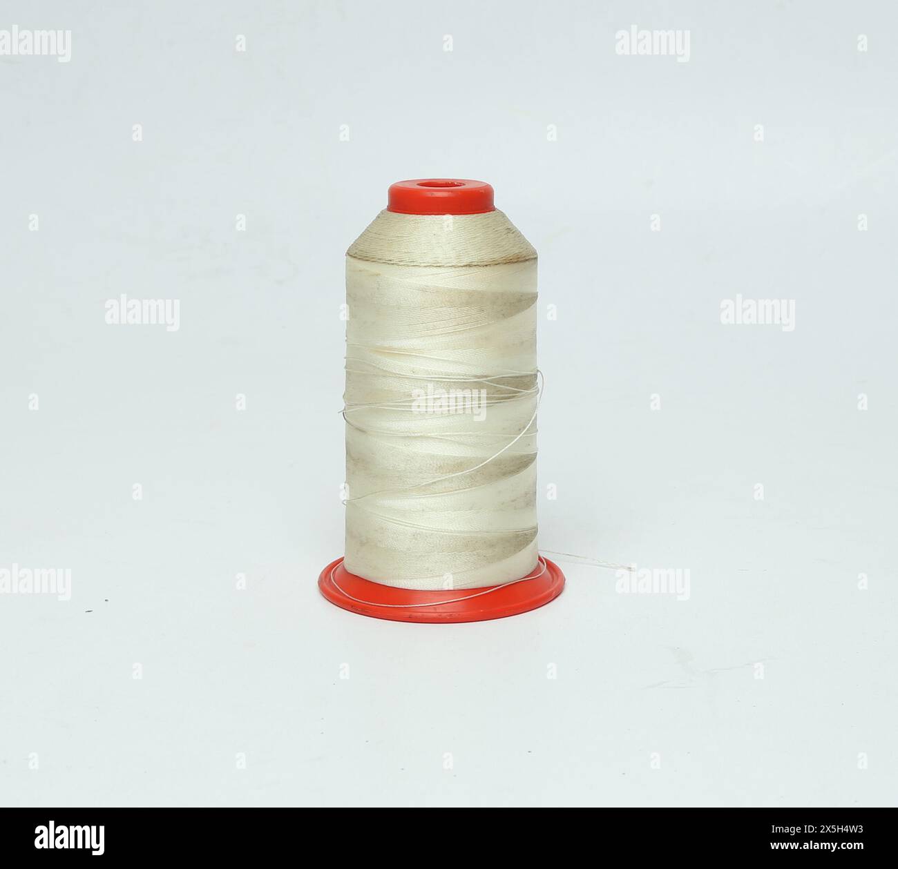 white thread roll isolated on white background Stock Photo - Alamy