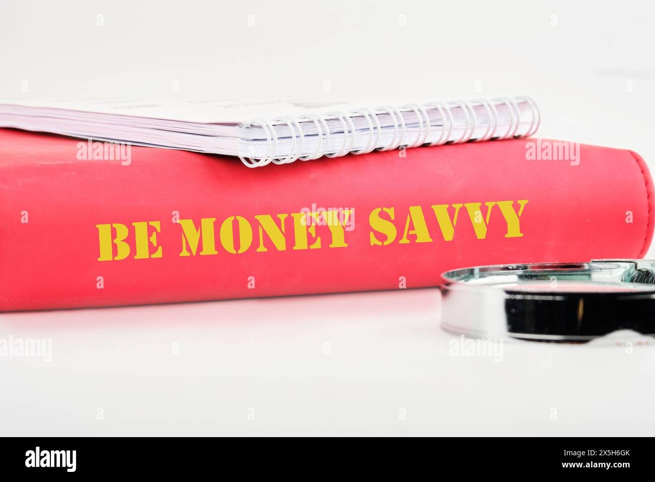 Savings concept,Text Be money savvy on the back of the book cover, a ...