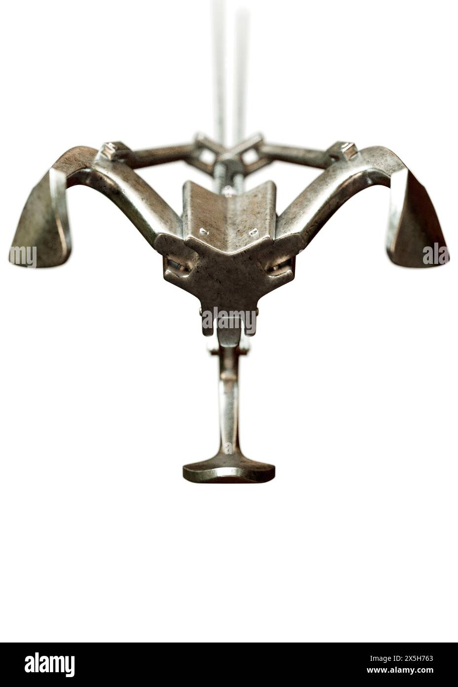 An open metal claw from a vintage arcade type grabber game connected to ...