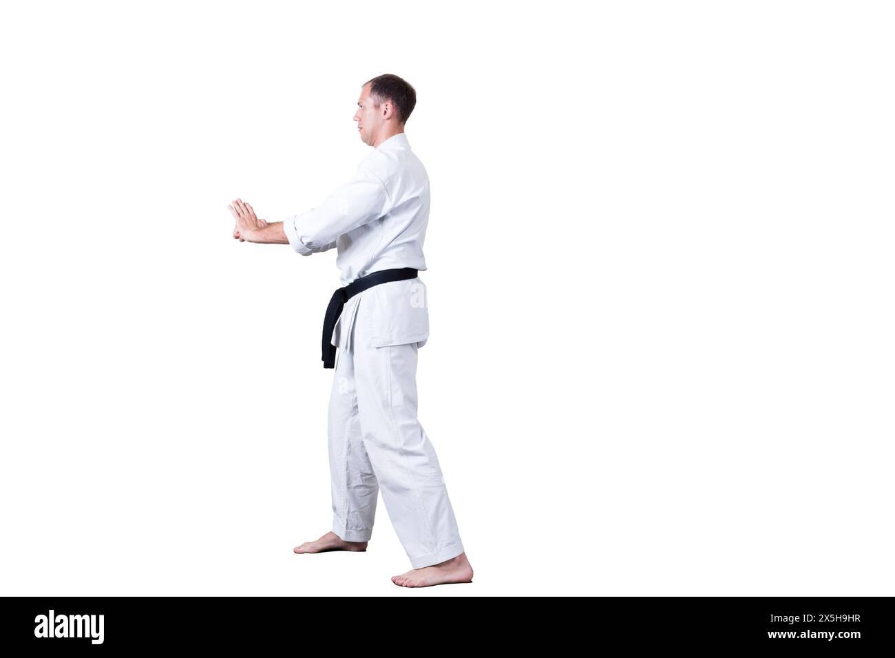 Adult athlete performs formal goju-ryu exercises. It is isolated in a ...