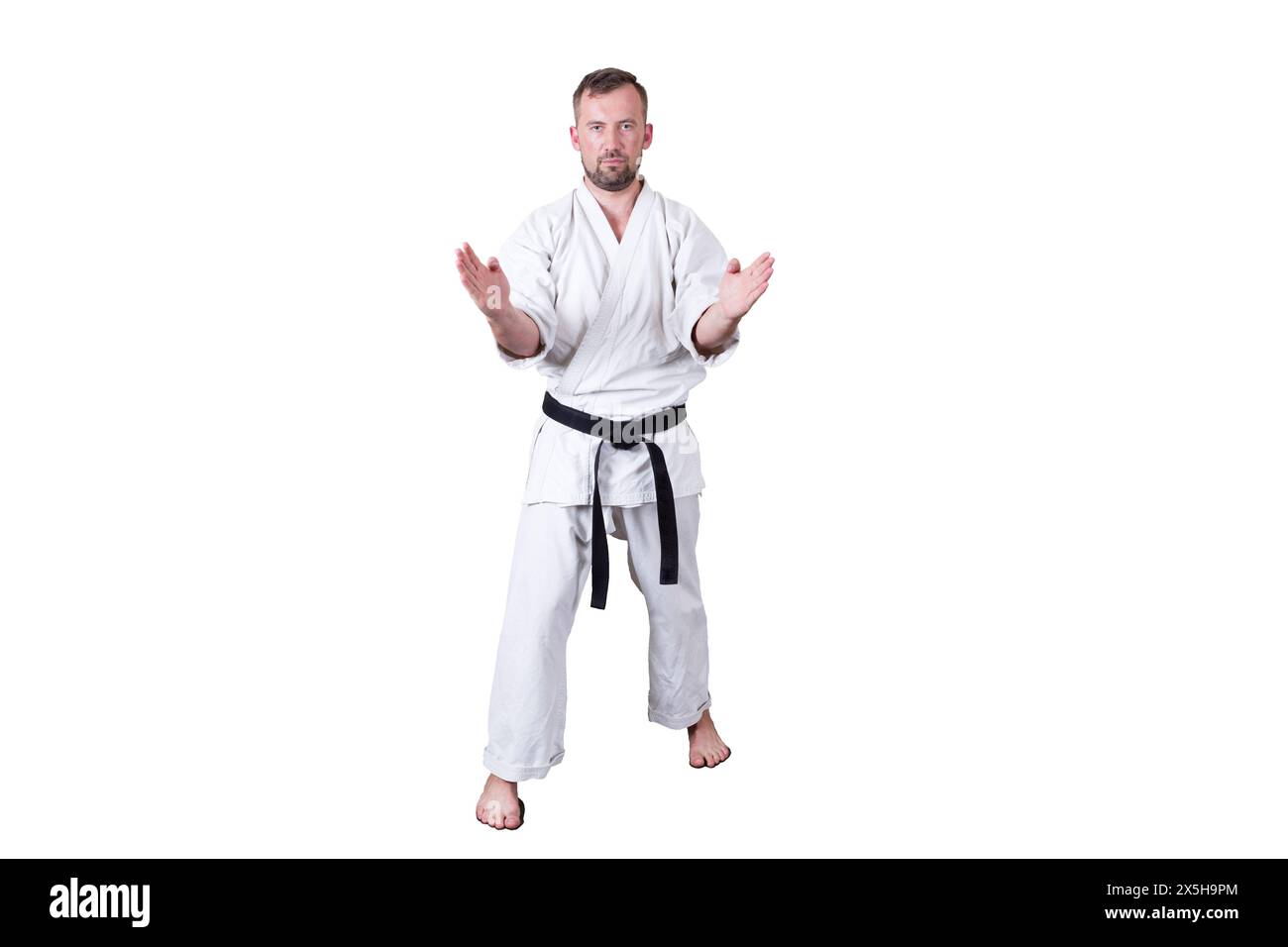 Adult athlete performs formal goju-ryu exercises. It is isolated in a ...