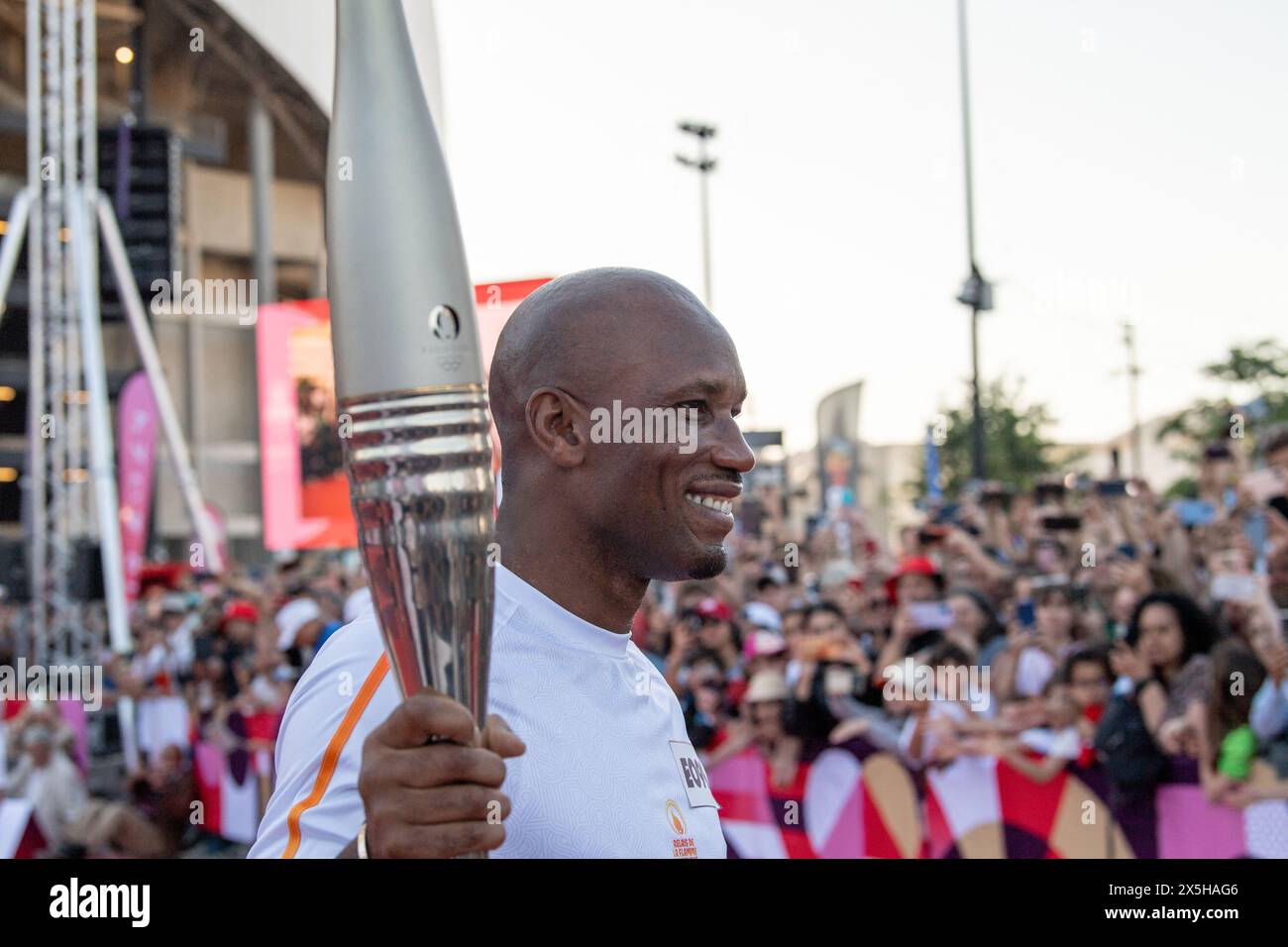 French Ivorian former football player Didier Drogba holds the Olympic ...