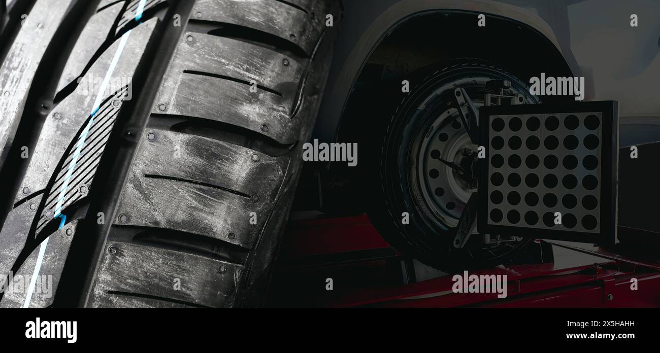 Car tire tread and car wheel alignment at the auto repair shop , double ...