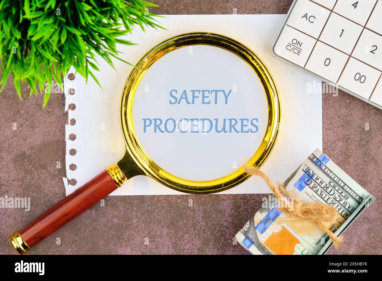 SAFETY PROCEDURES text written through a magnifying glass on a piece of ...