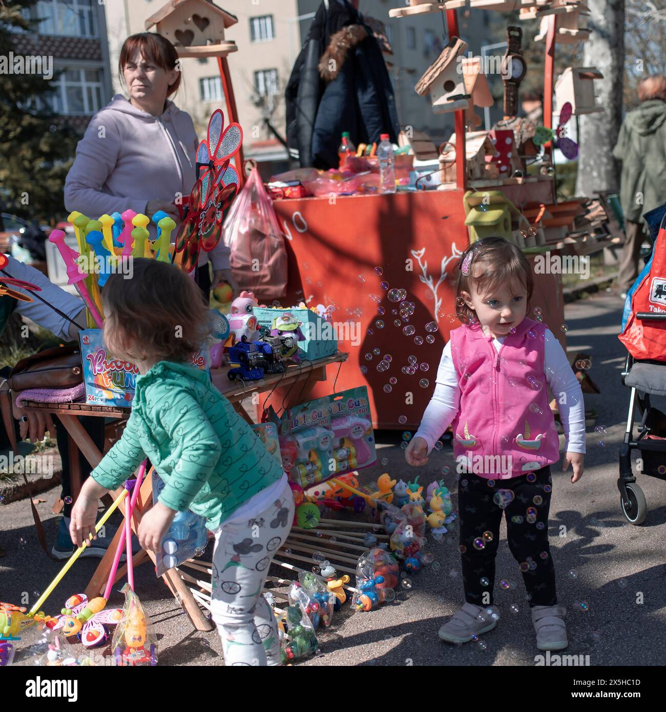 Belgrade, Serbia, Mar 23, 2024: Children playing around the toy stall ...