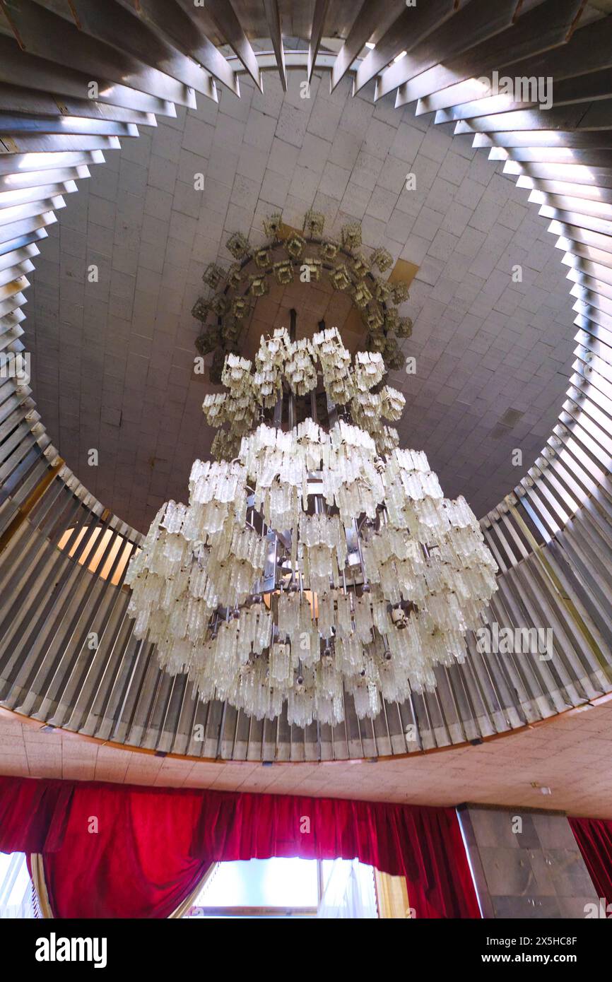View of a huge, intricate hanging, glass chandelier in the lobby. At ...